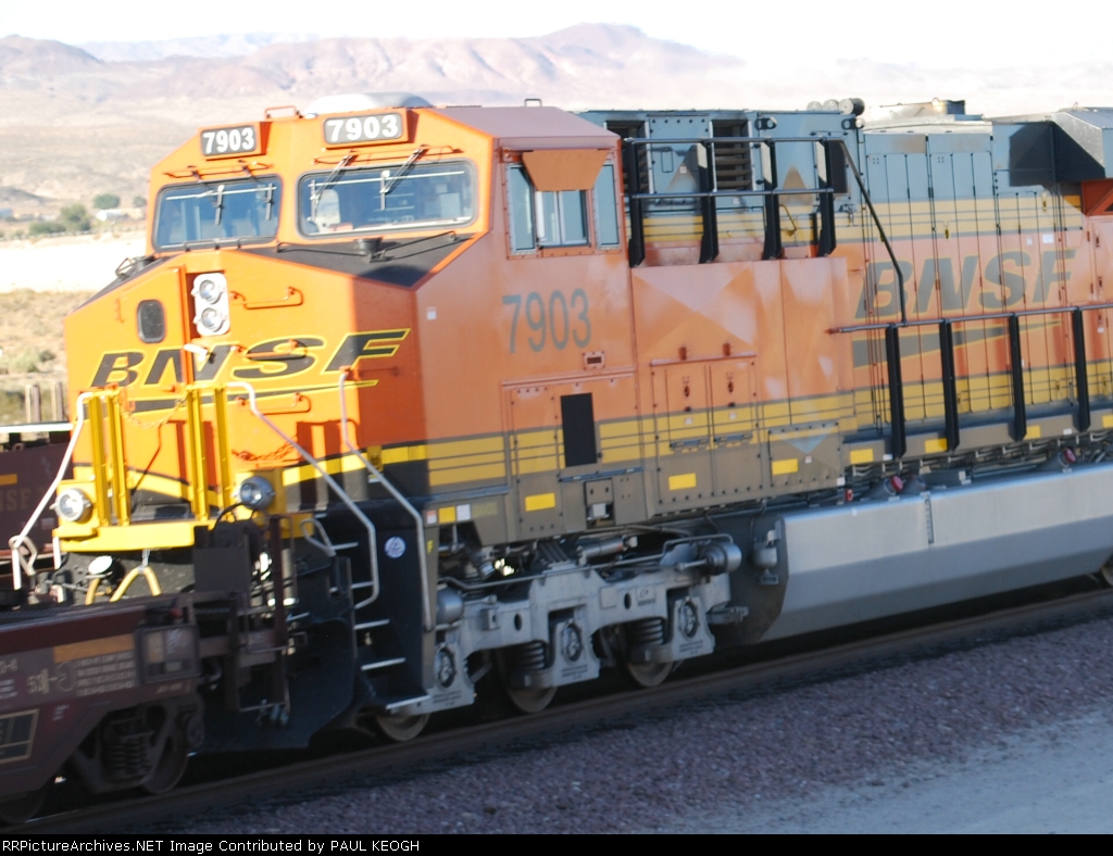 BNSF 7903 rolls eastbound at sunset as a #4 unit on a east Z as she slows down for a crew change ...